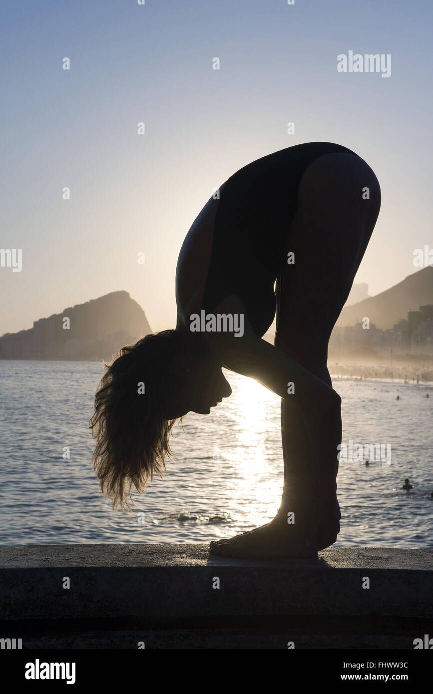 Woman May in yoga pose in Leme Beach - south Stock Photo - Alamy
