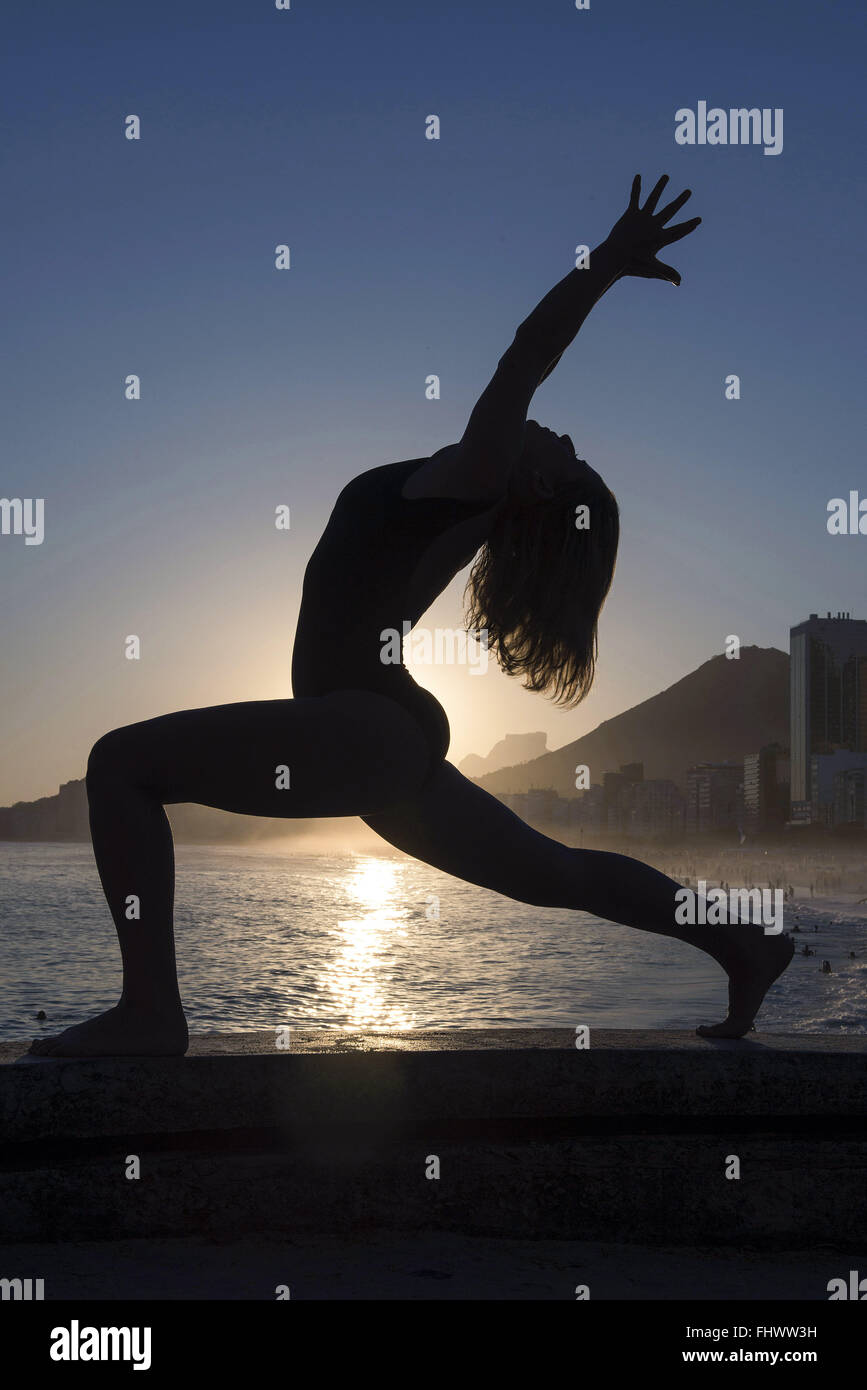 Woman May in yoga pose in Leme Beach - south Stock Photo - Alamy
