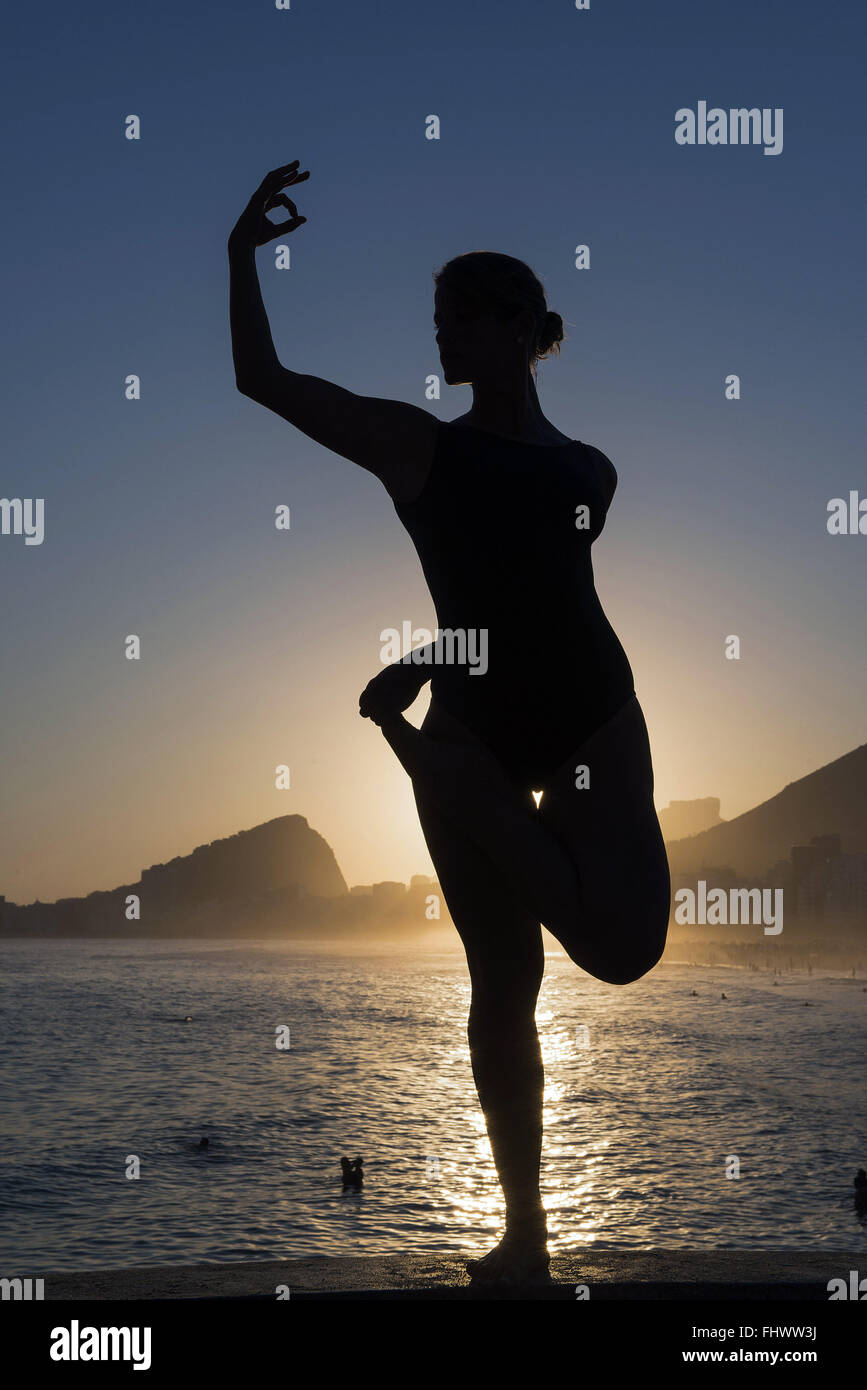 Woman May in yoga pose in Leme Beach - south Stock Photo - Alamy
