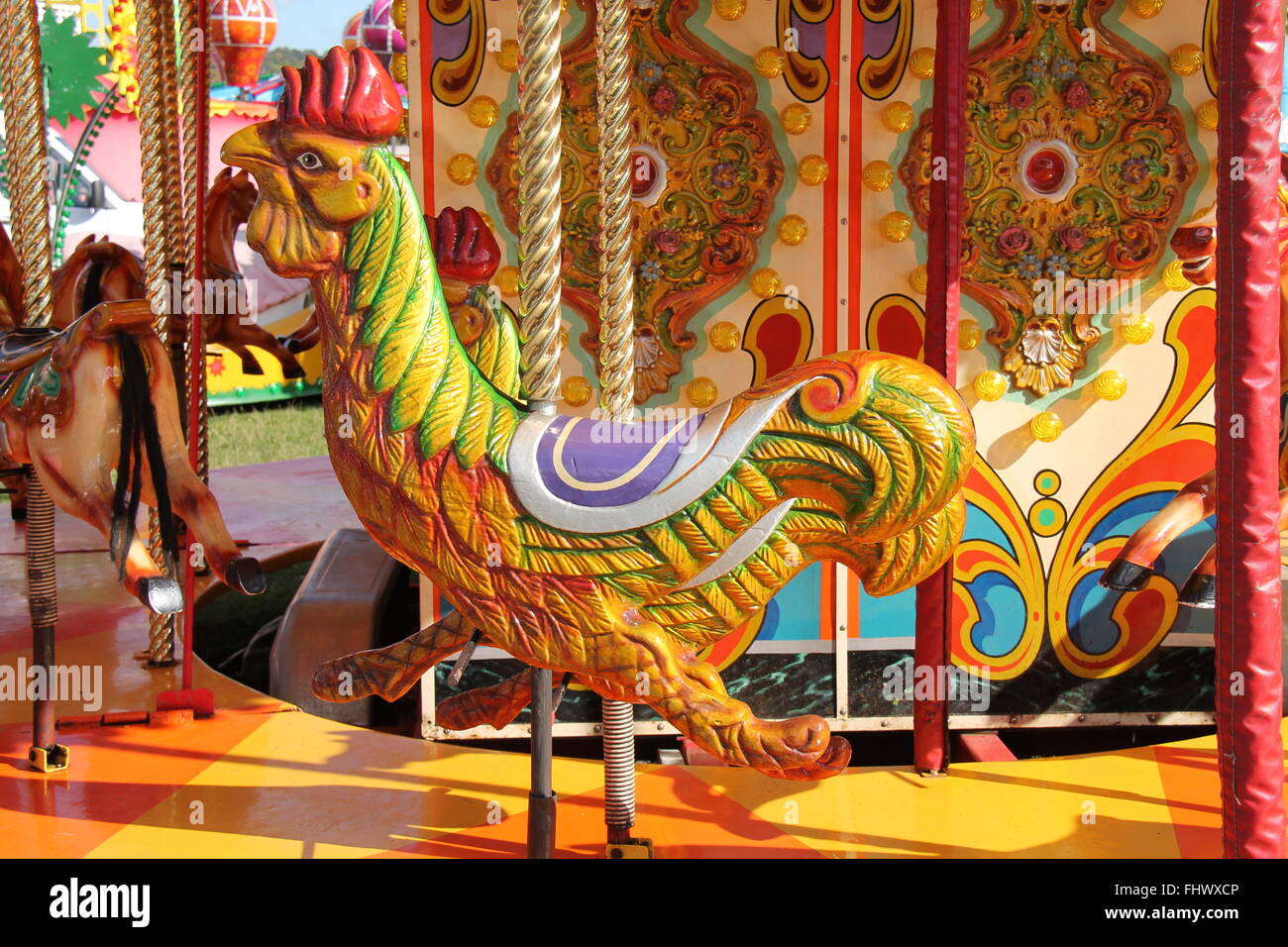 A Rooster Chicken Seat on a Fun Fair Carousel Ride Stock Photo - Alamy