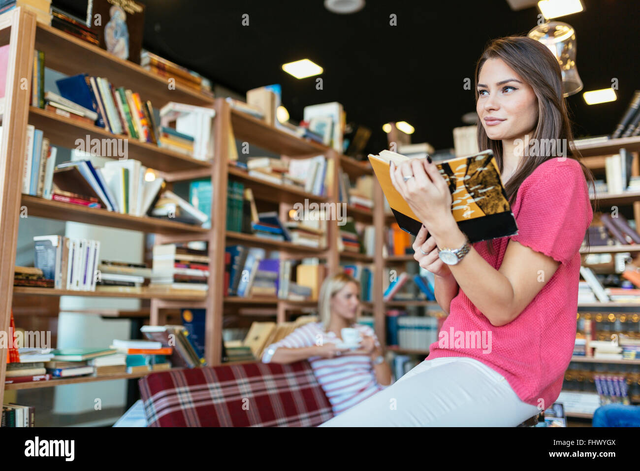 Intellectual students reading books in library Stock Photo - Alamy