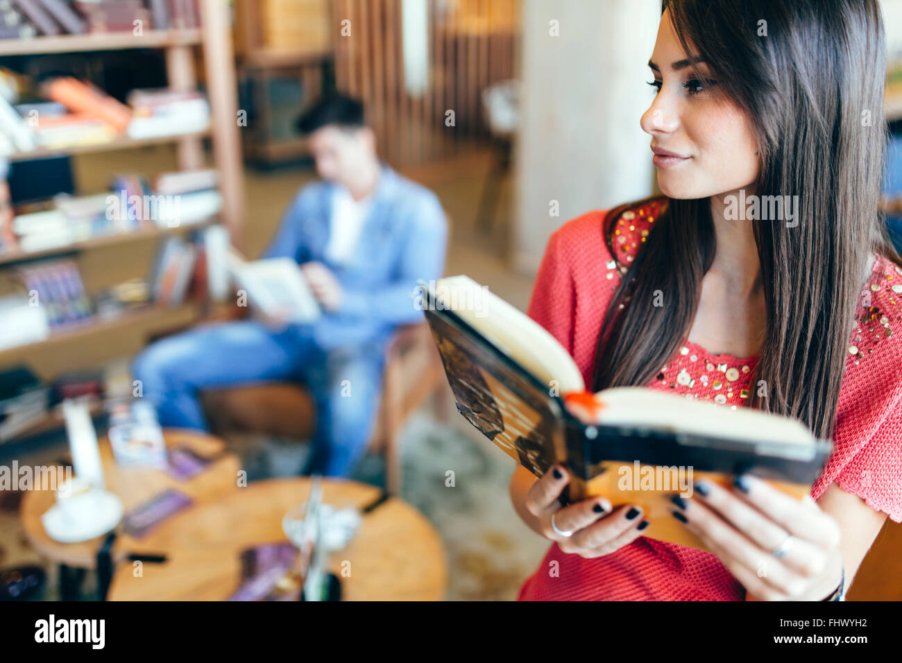 Beautiful woman reading book and preparing for exam Stock Photo - Alamy
