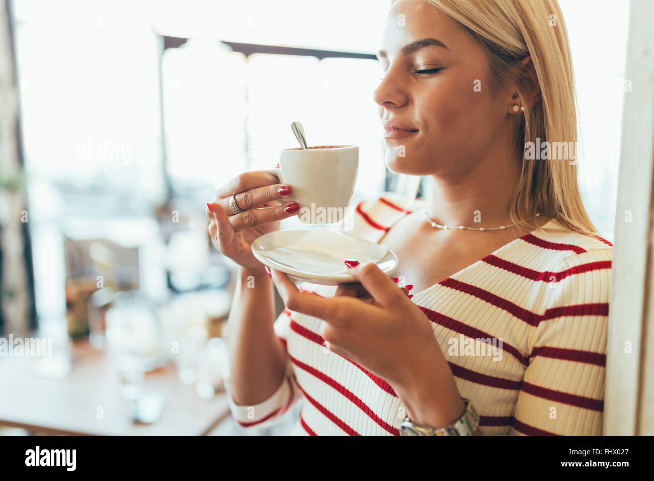 Portrait of a beautiful woman drinking coffee, tea in a cafe Stock ...