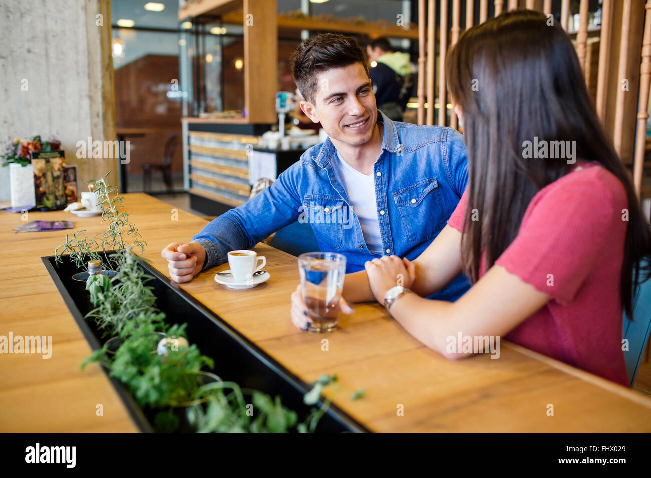 Happy young couple in restaurant waiting for food and talking Stock ...