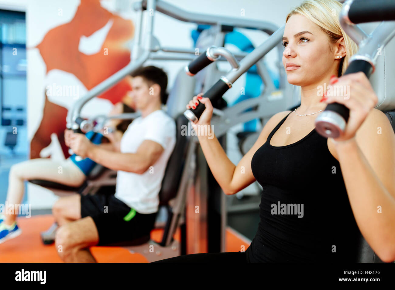 People exercising in gym on various machines Stock Photo - Alamy