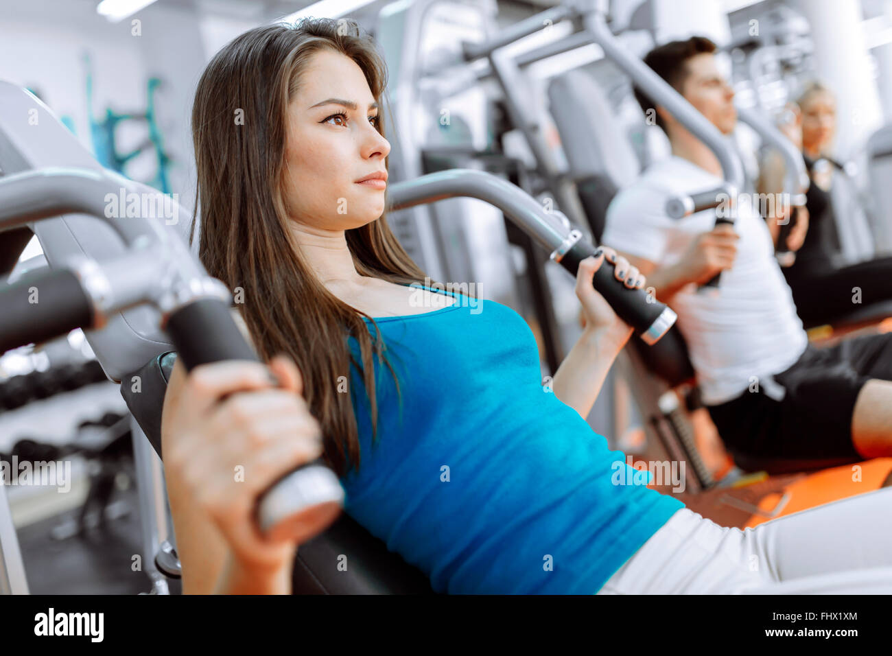 People exercising in gym on various machines Stock Photo - Alamy