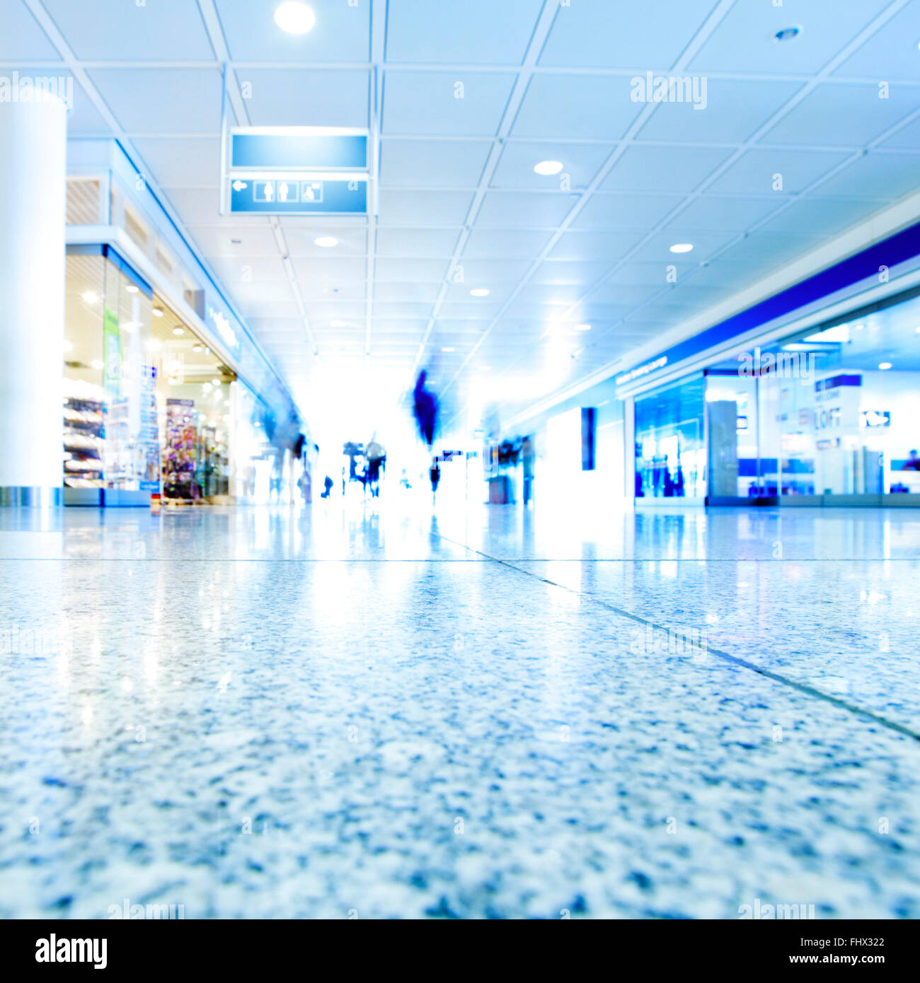 Passengers walking in contemporary hallway of airport Stock Photo - Alamy