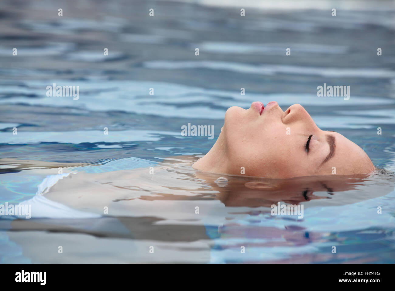 Woman floating and relaxing in tropical ocean water Stock Photo - Alamy