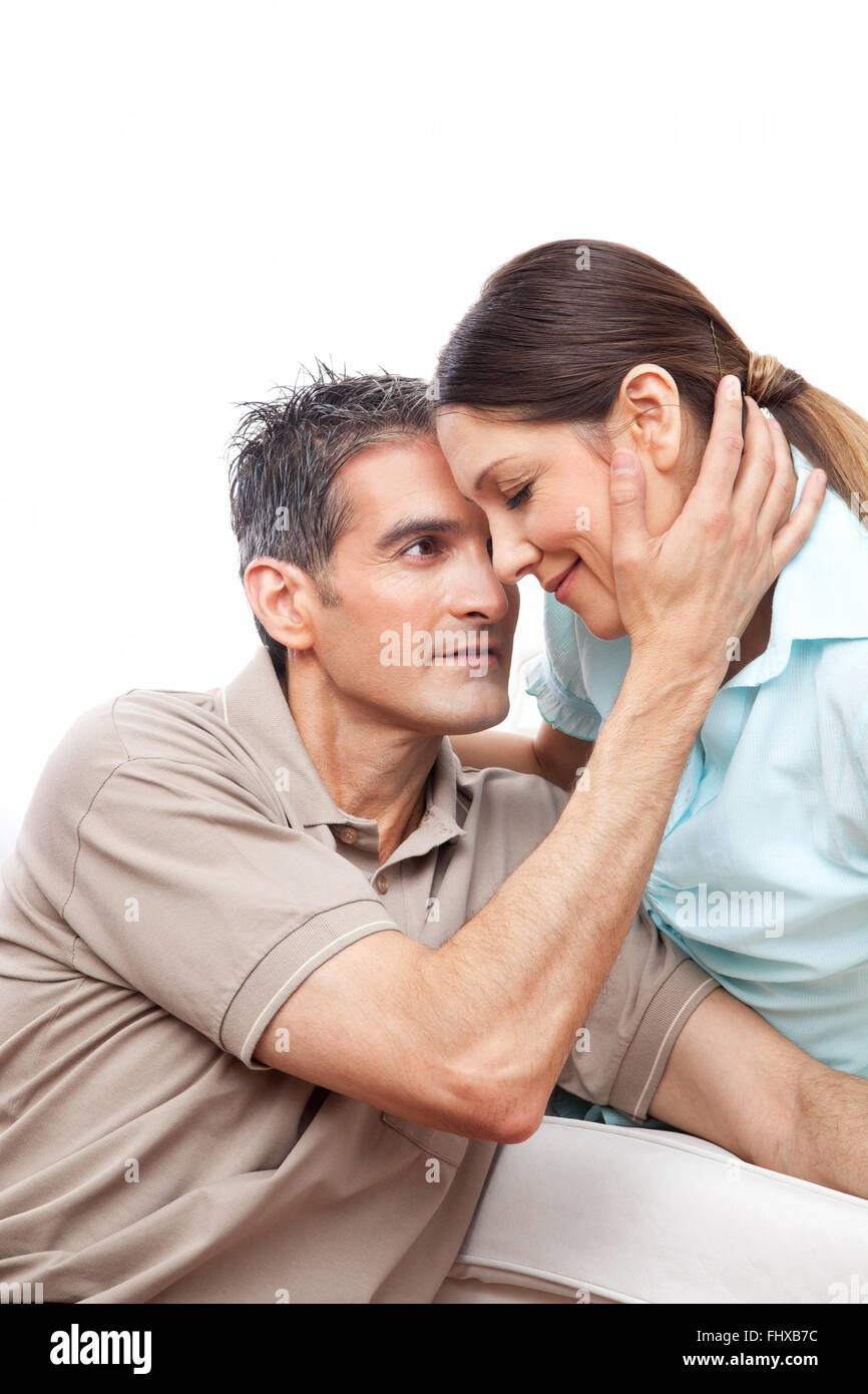 Man caressing his smiling woman on couch Stock Photo - Alamy