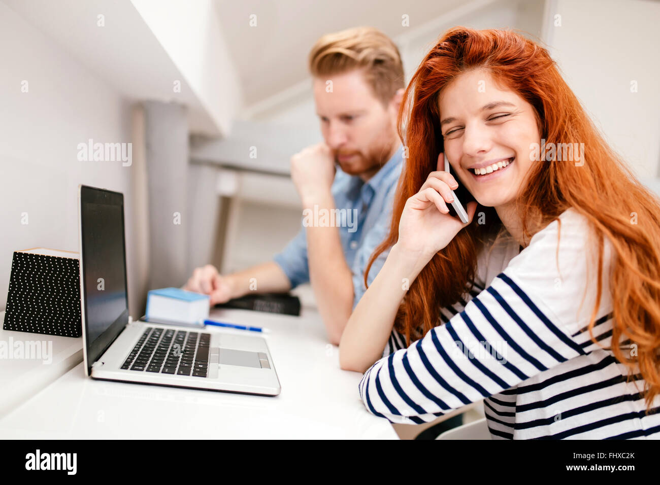 Beautiful woman calling in a white office and talking to potential ...