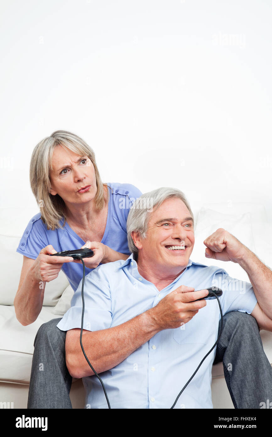 Two happy seniors playing video games at home Stock Photo - Alamy