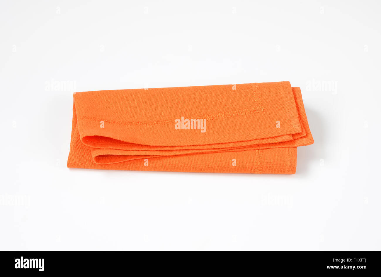 Orange napkin folded twice vertically Stock Photo - Alamy