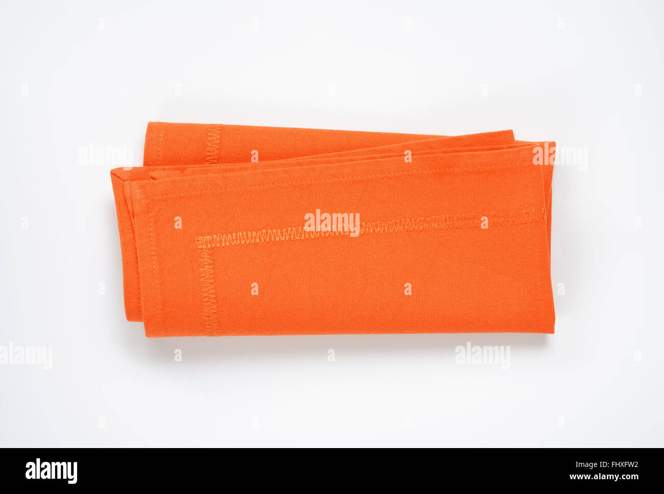 Orange napkin folded twice vertically Stock Photo - Alamy