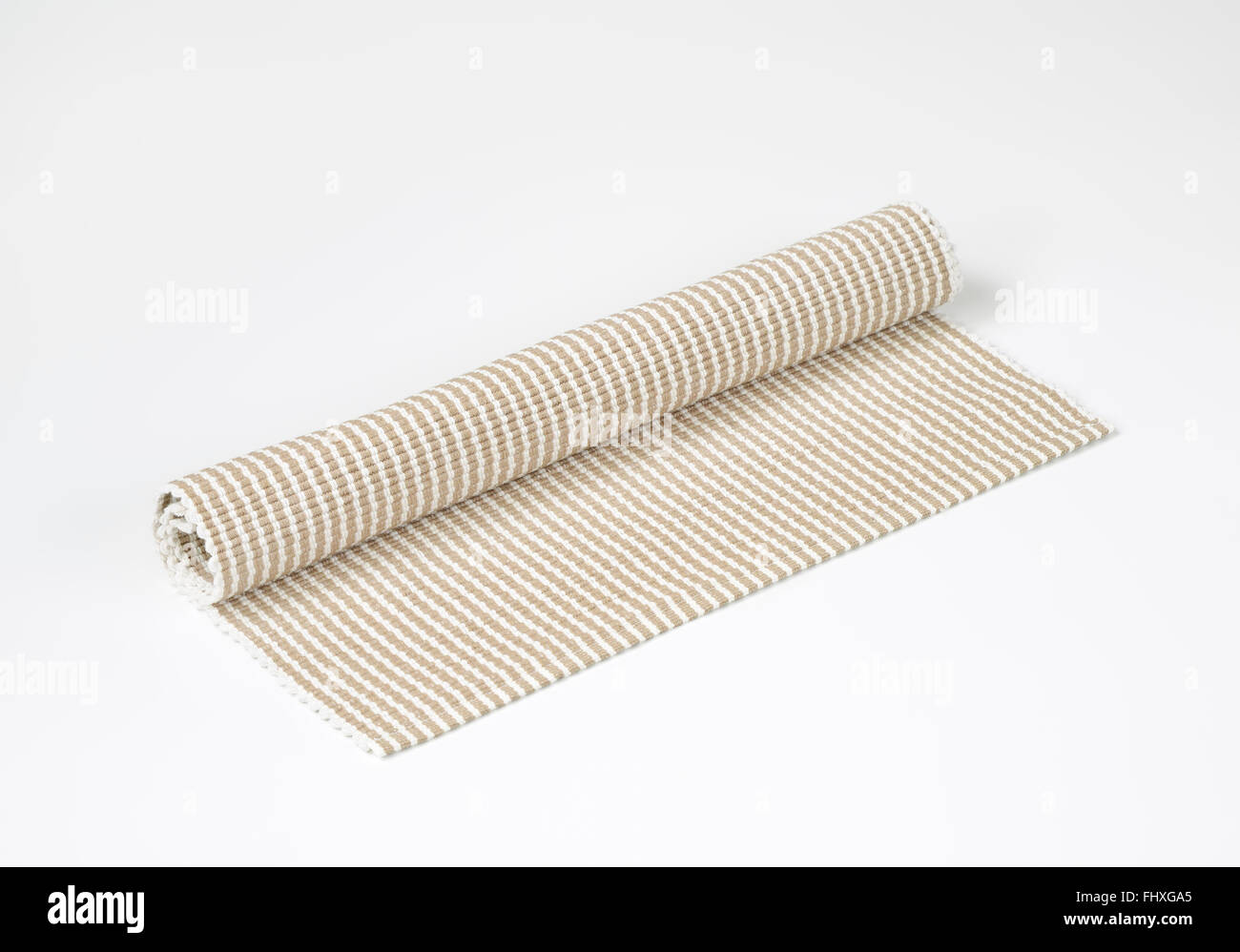 Rolled woven cotton table mat Stock Photo - Alamy