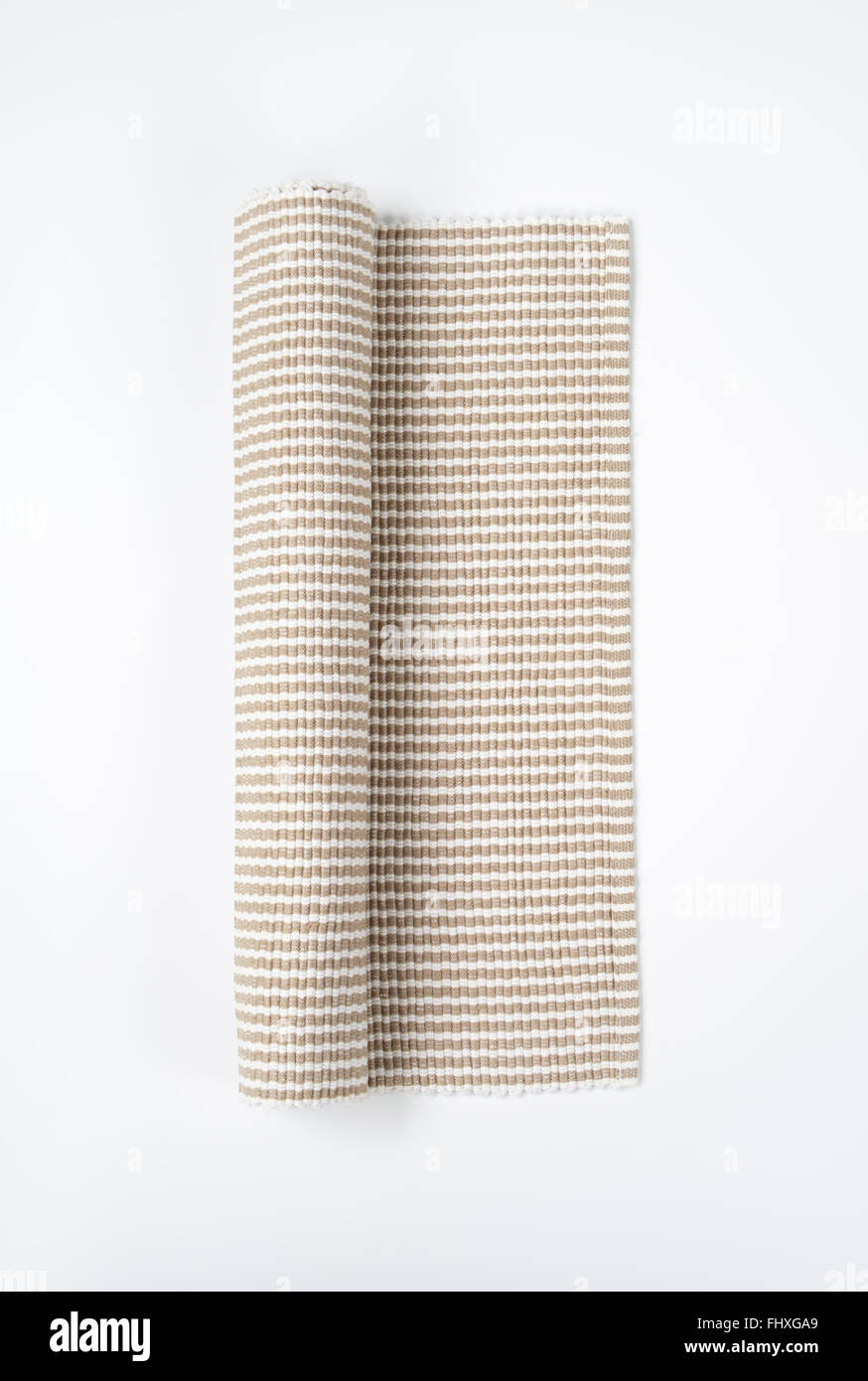 Rolled woven cotton table mat Stock Photo - Alamy