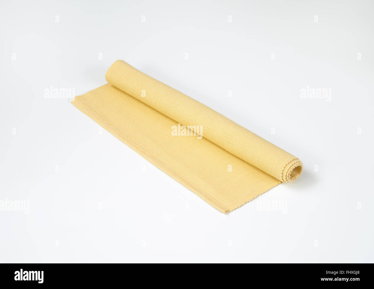 Rolled beige cotton table mat on white background Stock Photo - Alamy