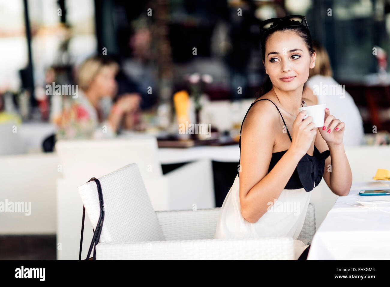 Attractive female drinking tea from cup Stock Photo - Alamy