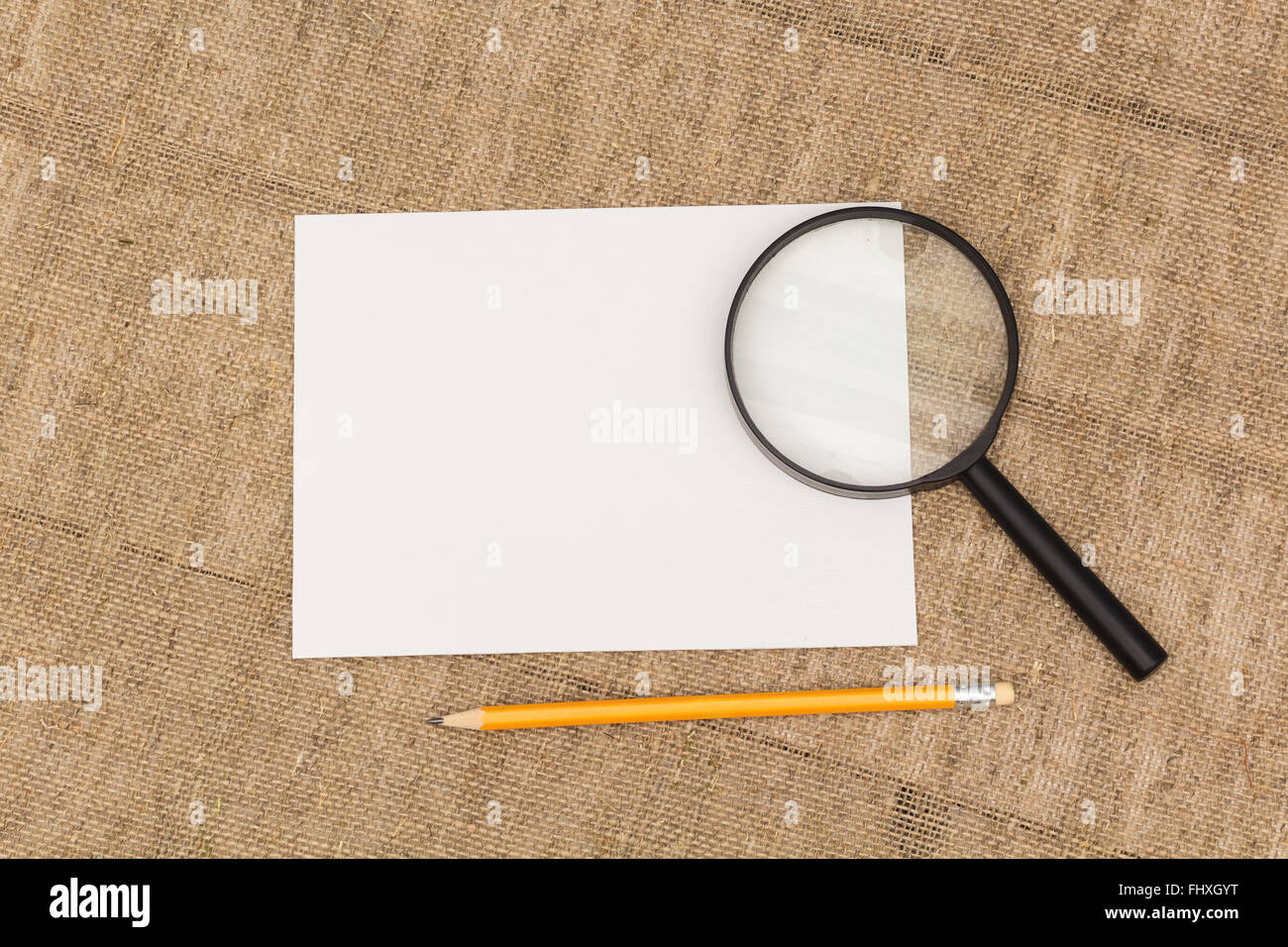 white sheet of paper and magnifying glass, view from above Stock Photo ...