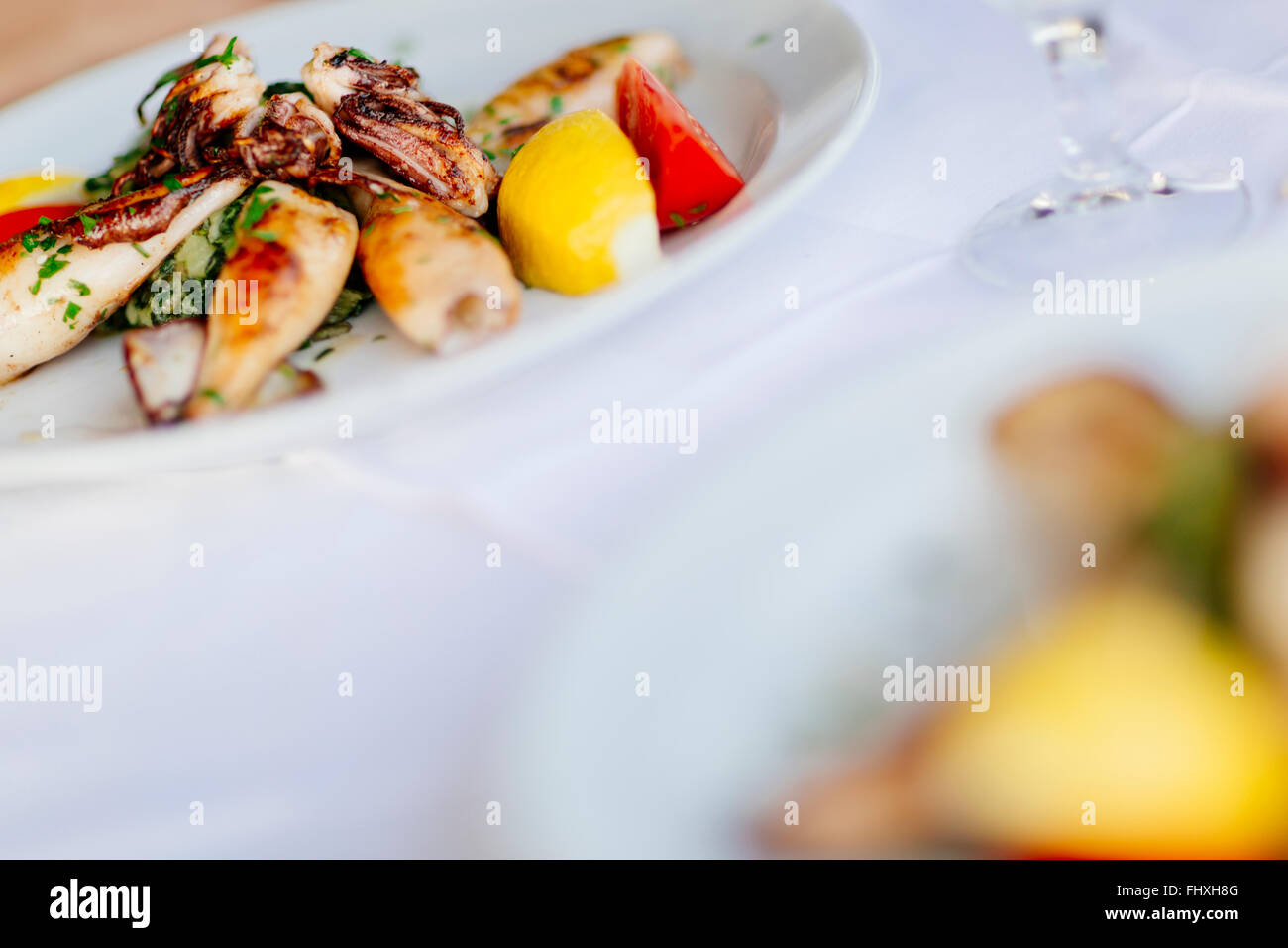 Grilled squid served on plate Stock Photo - Alamy