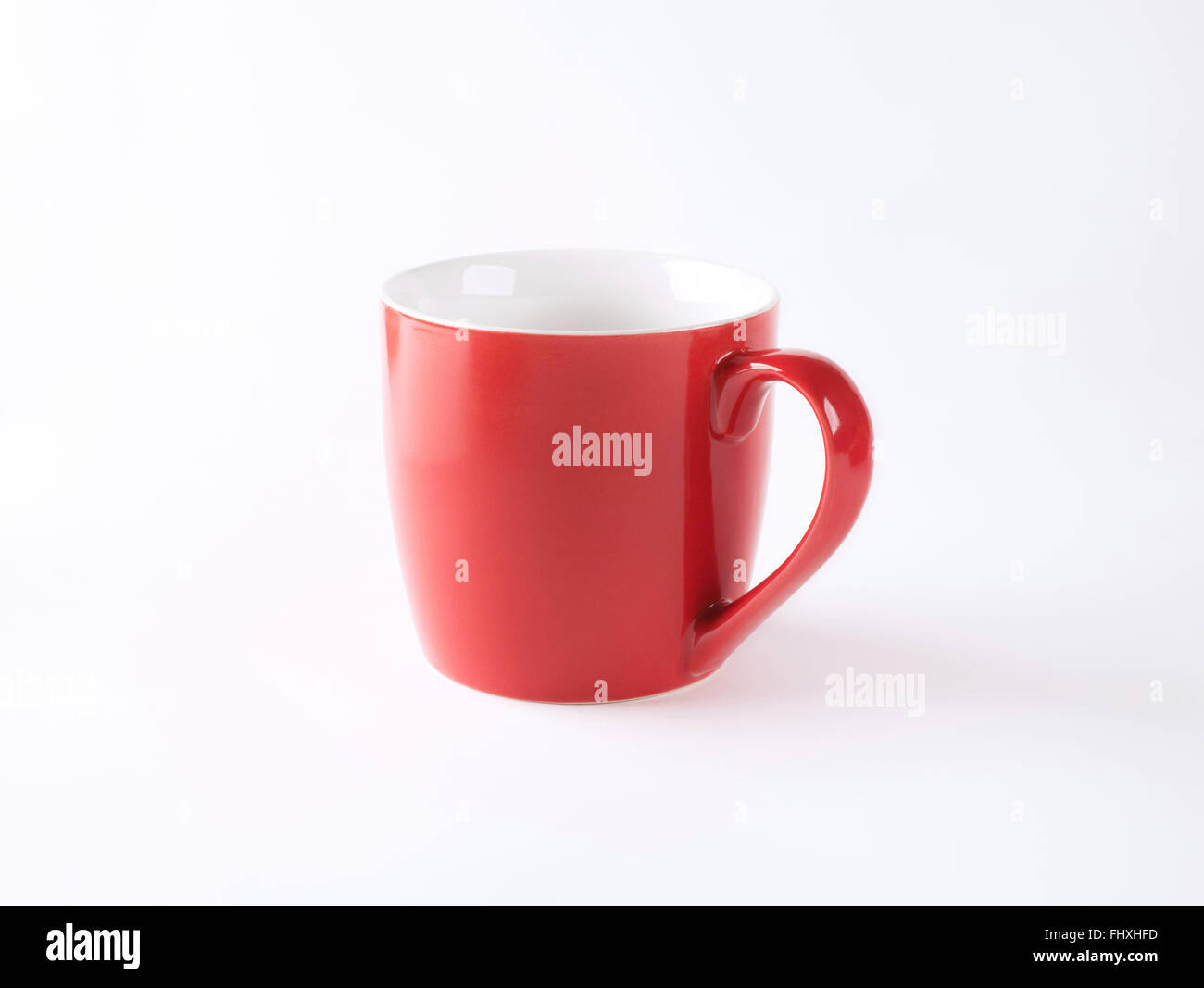 empty red mug on white background Stock Photo - Alamy