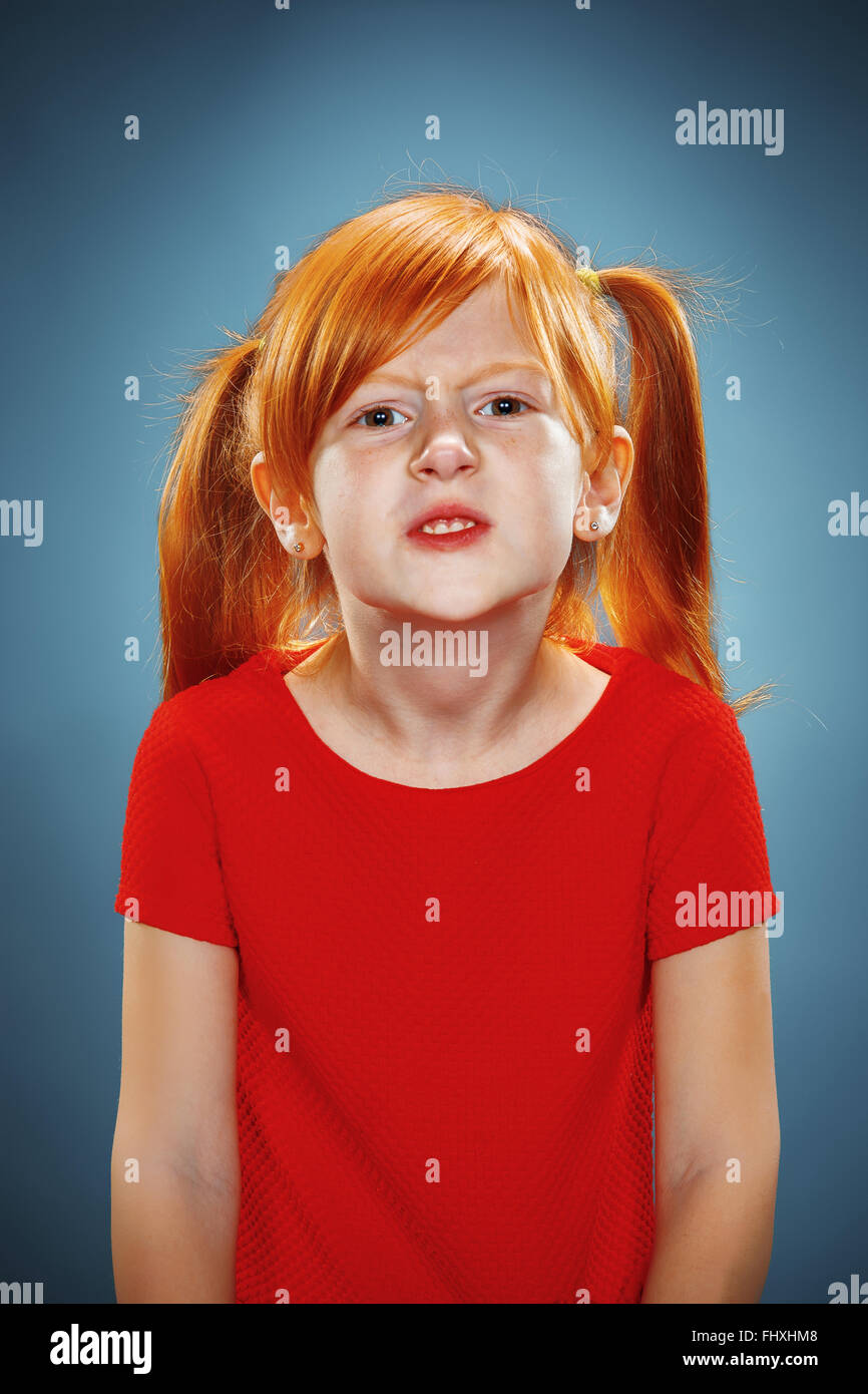 The beautiful portrait of displeased and disaffected little girl in red ...