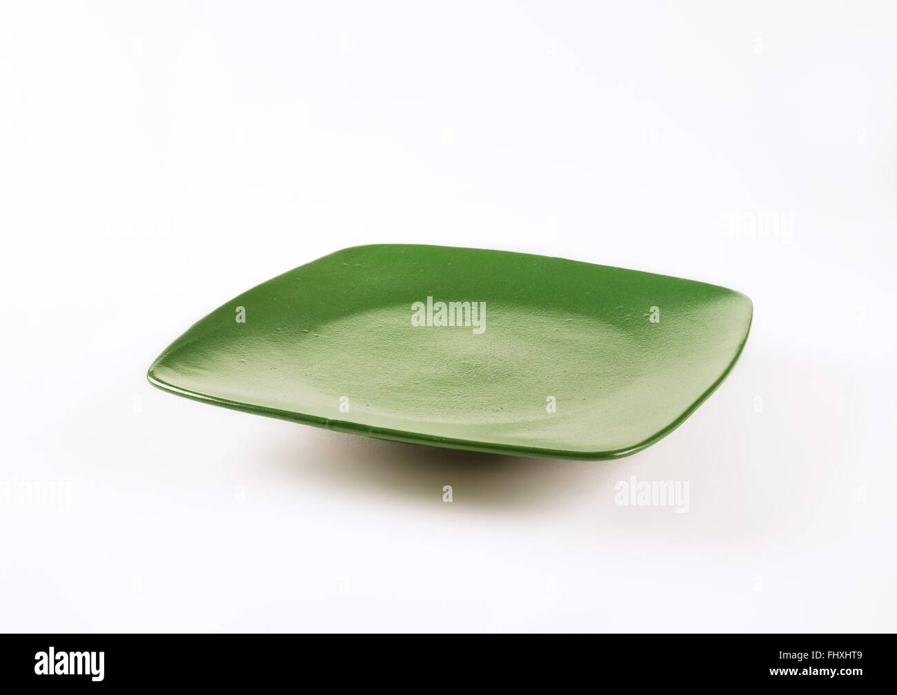 empty green plate on white background Stock Photo - Alamy