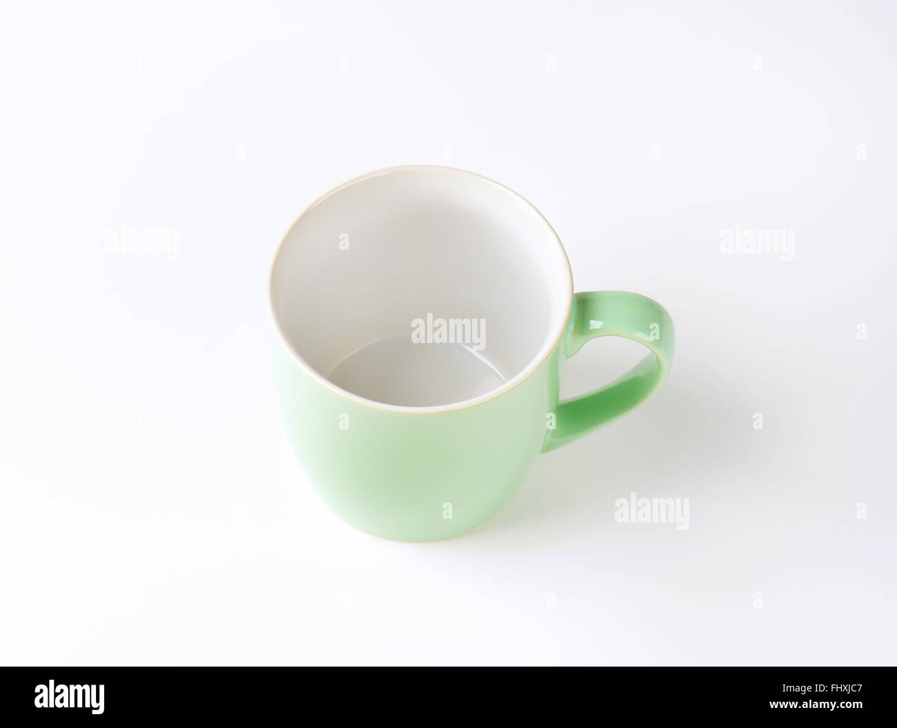 empty green mug on white background Stock Photo - Alamy