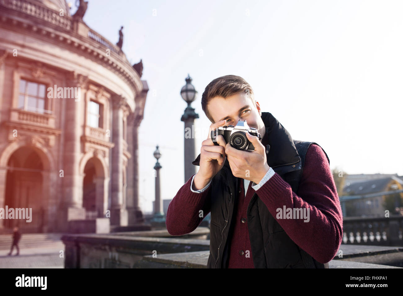 Germany, Berlin, young man taking picture at Bode Museum Stock Photo ...