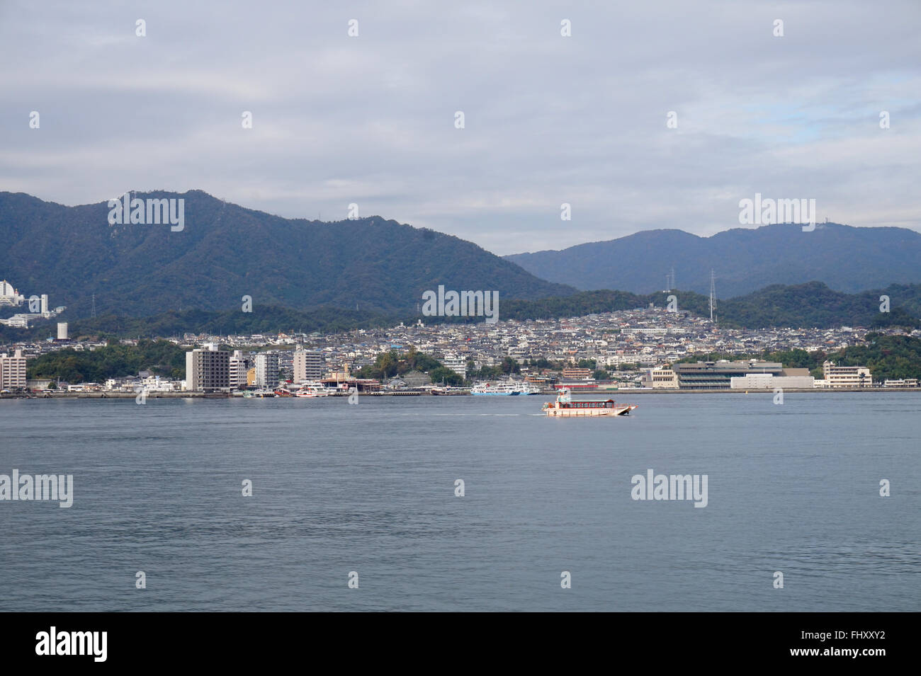 A tourist on the ferry to Miyajima island, Hiroshima, Japan Stock Photo ...