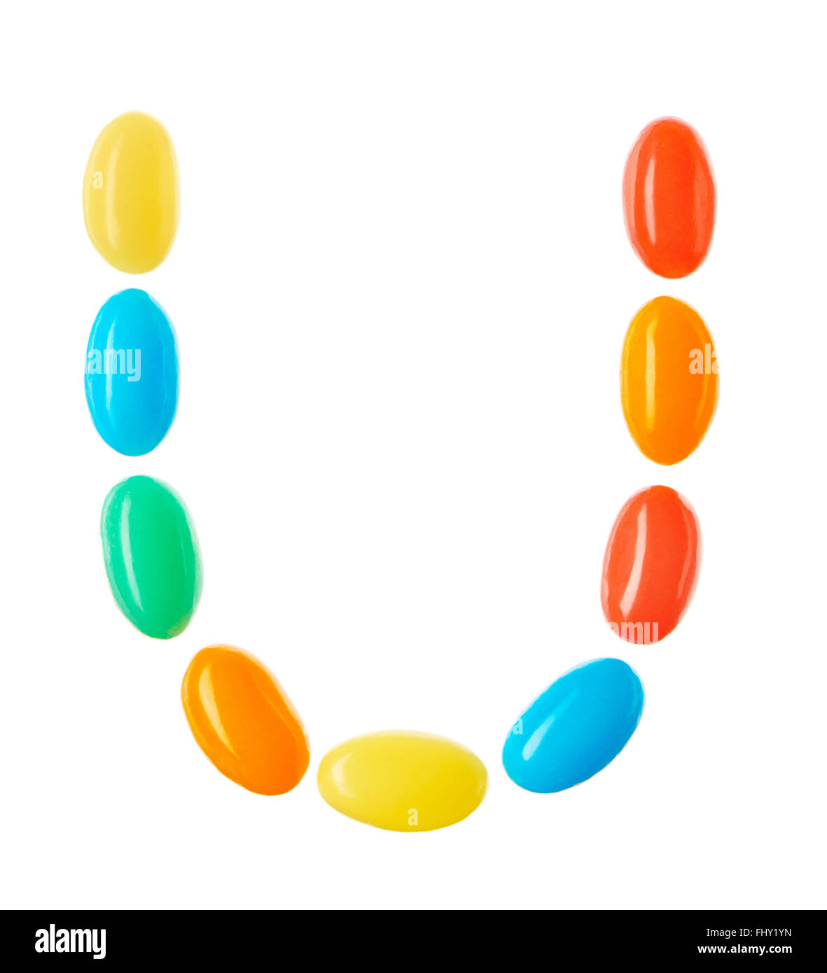 U letter made of multicolored candies isolated on white background ...