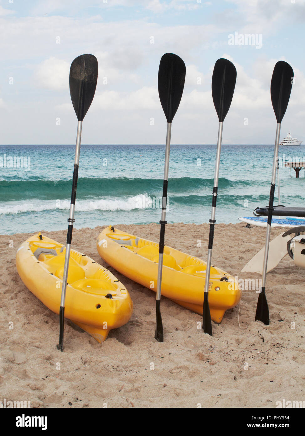 Paddles and kayaks on a mediterranean beach. Horizontal Stock Photo - Alamy