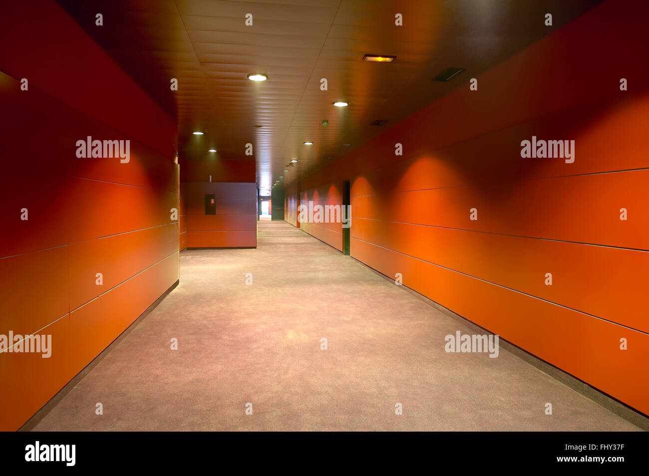 Modern building corridor with red walls. Horizontal Stock Photo - Alamy