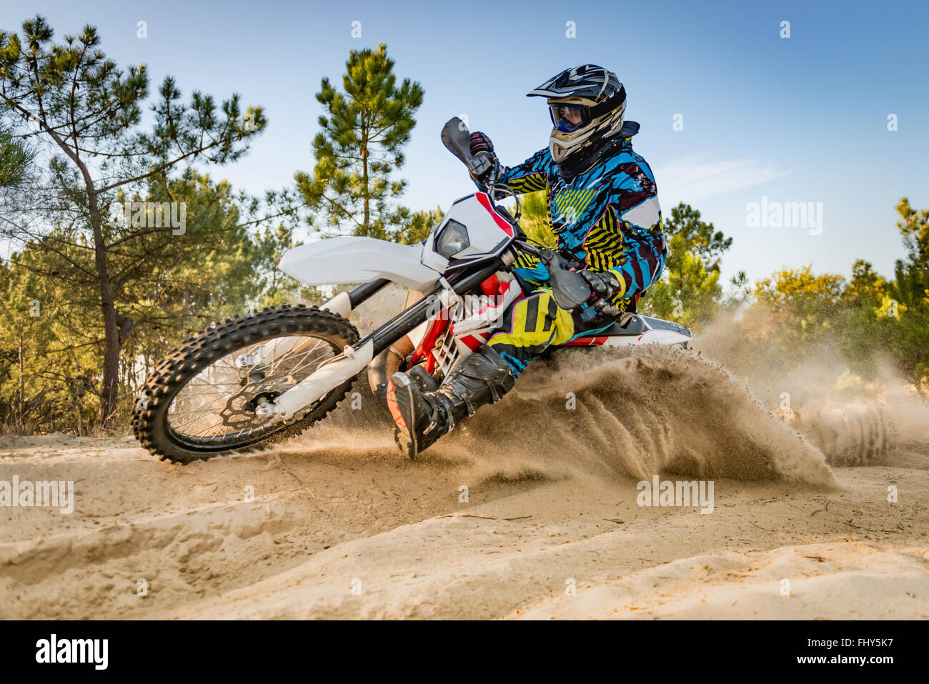 Enduro bike rider on action. Turn on sand terrain Stock Photo - Alamy