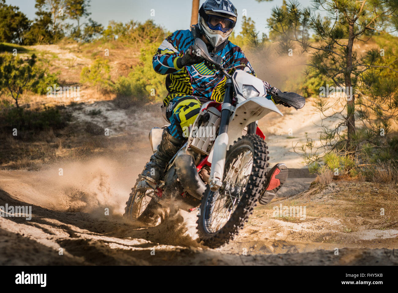 Enduro bike rider on action. Turn on sand terrain Stock Photo - Alamy