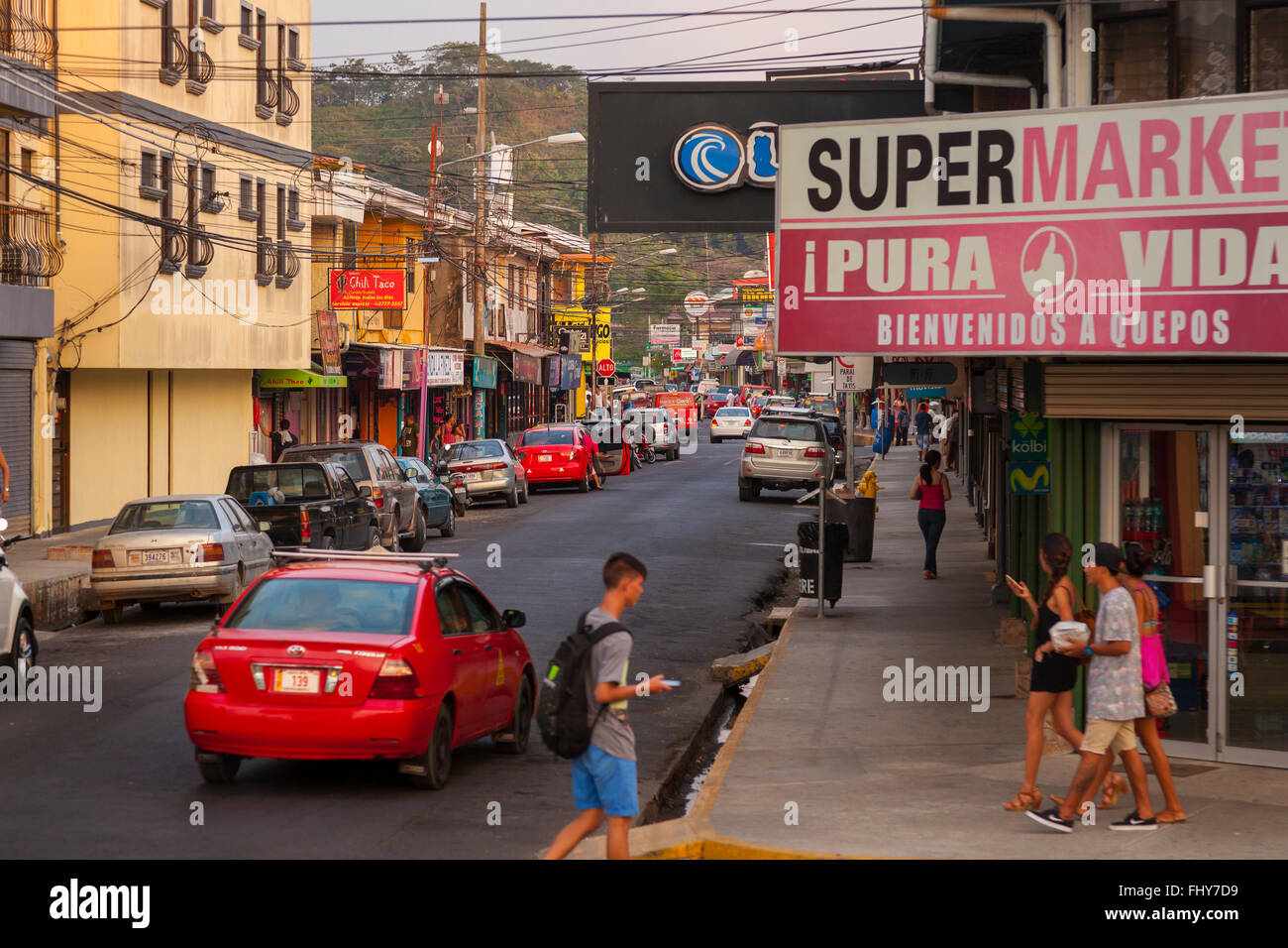 A compressed perspective shows many storefronts in a busy downtown ...