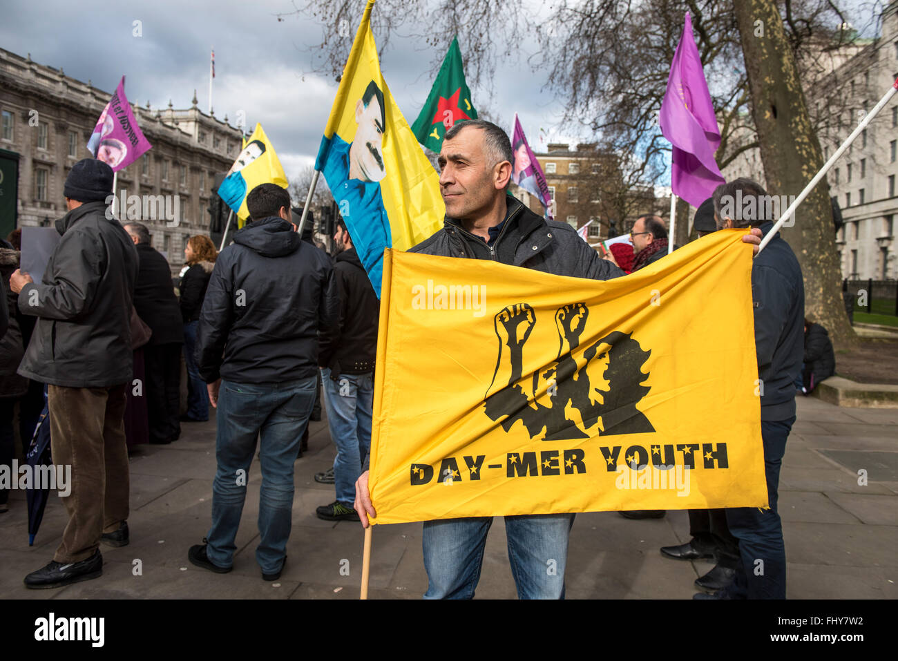 Man is holding yellow "Day-Mer Youth" flag during the Kurds protest ...