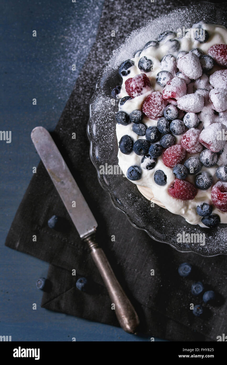 Vintage cake stand with Meringue dessert Pavlova with sugar powder ...