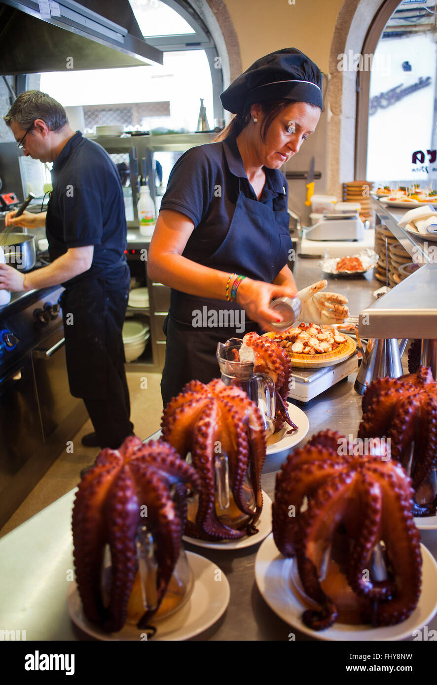 Preparing `Pulpo a feira´ octopus in Galician style, Pulpería María ...