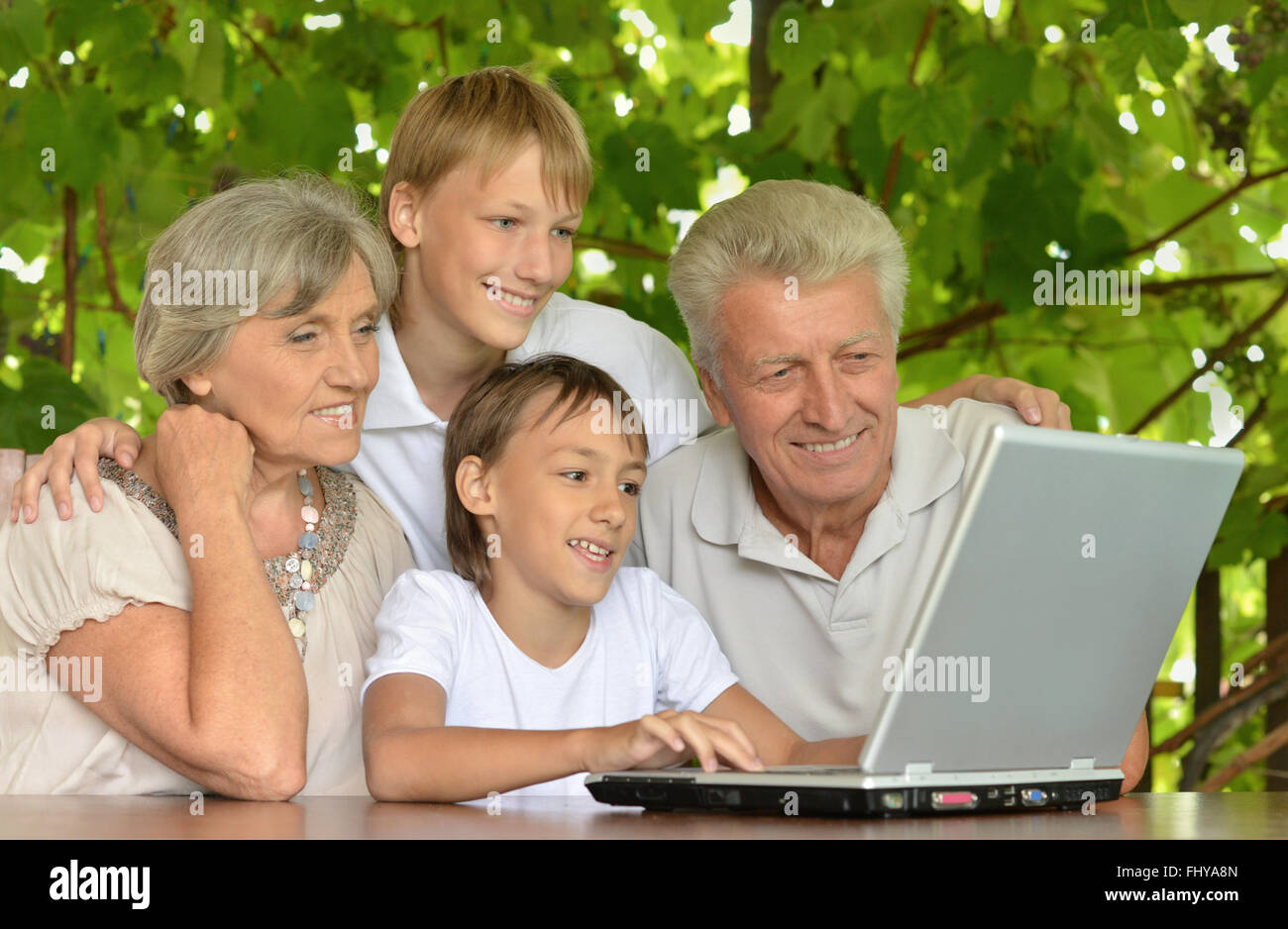 Family with laptop Stock Photo - Alamy