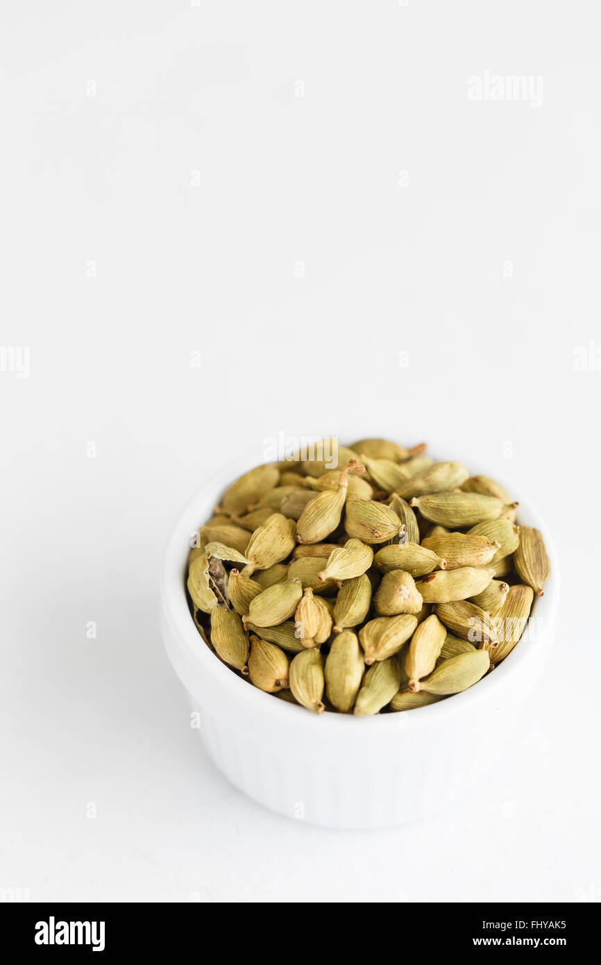 Green Cardamom in a white bowl Stock Photo - Alamy
