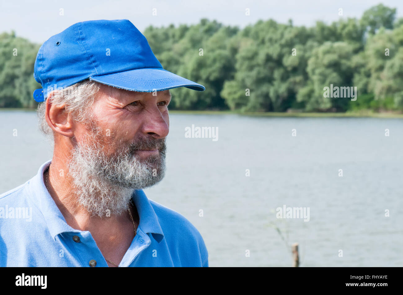 Typical fisherman with white beard and blue hat at river Stock Photo ...