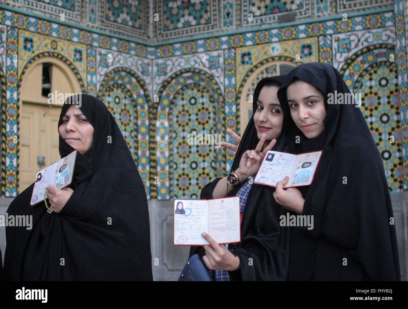 Qom, Iran. 26th Feb, 2016. Women hold their identity card at a polling ...