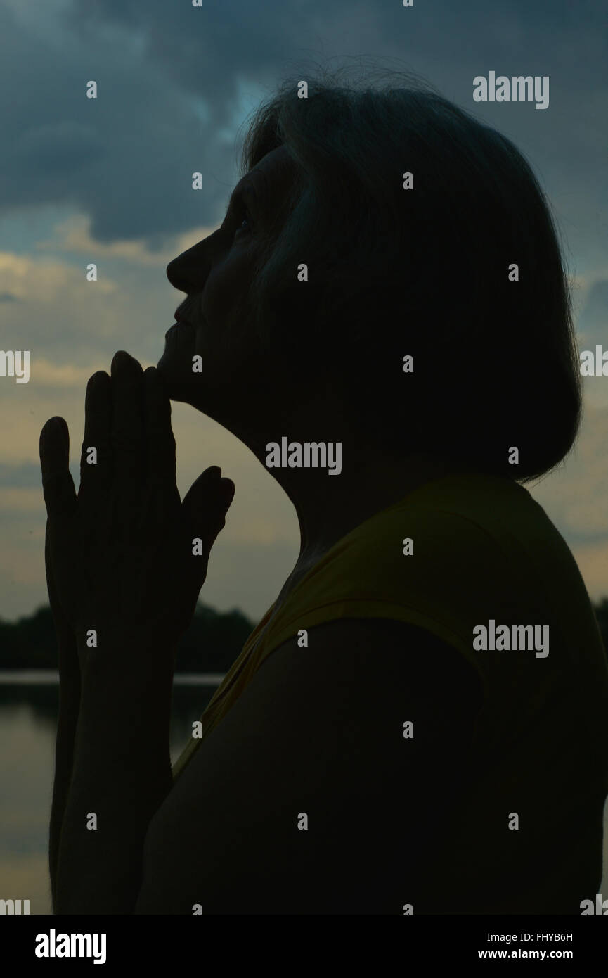 praying olderly woman Stock Photo - Alamy
