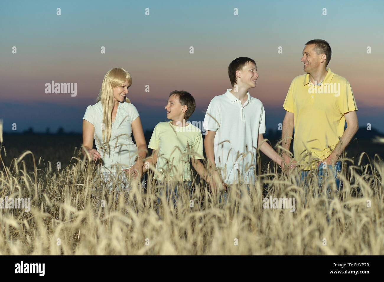 Family standing in field Stock Photo - Alamy