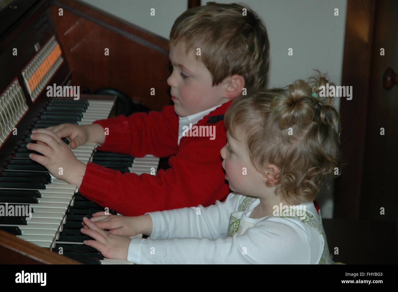 Young children playing organ Stock Photo - Alamy