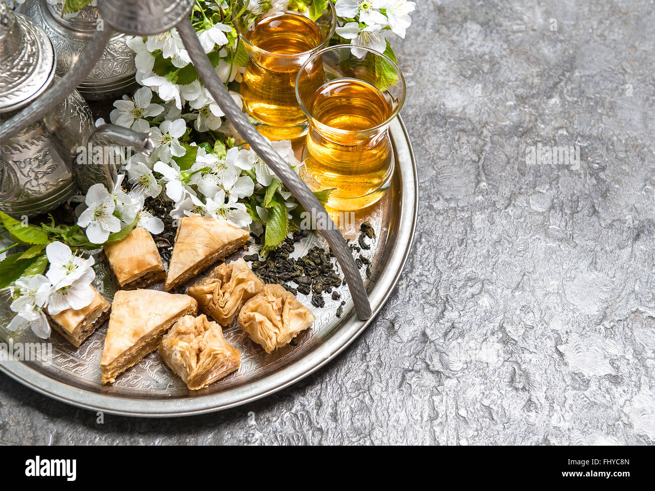 Tea glasses and pot, traditional sweets. Islamic holidays decoration ...