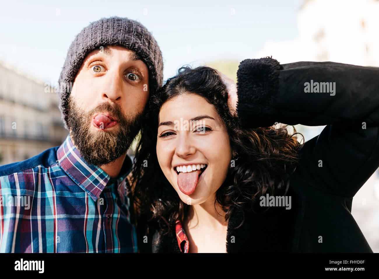Playful young couple pulling faces Stock Photo - Alamy