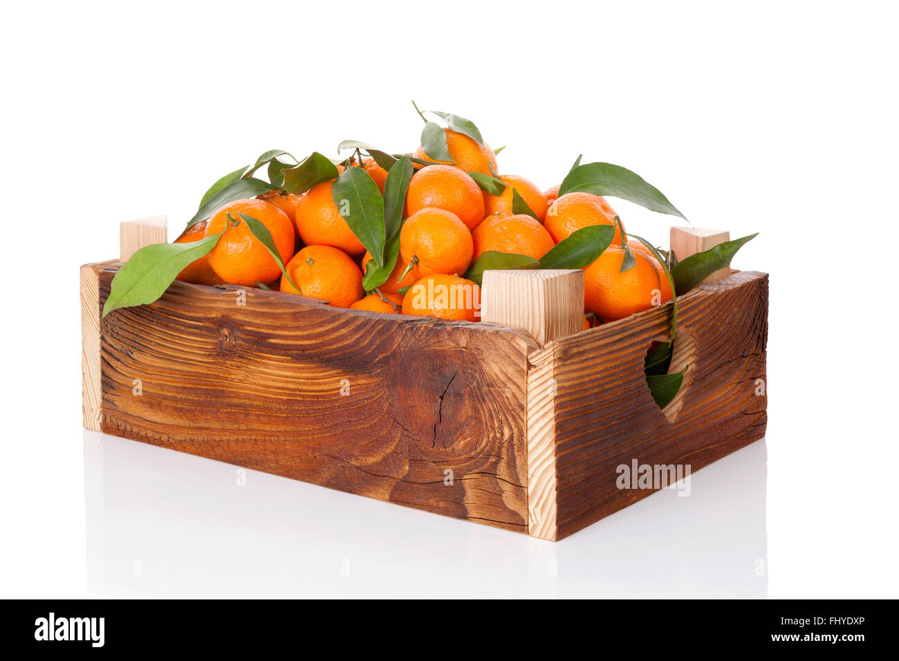 Fresh ripe mandarines with green leaves in wooden crate. Organic fresh ...