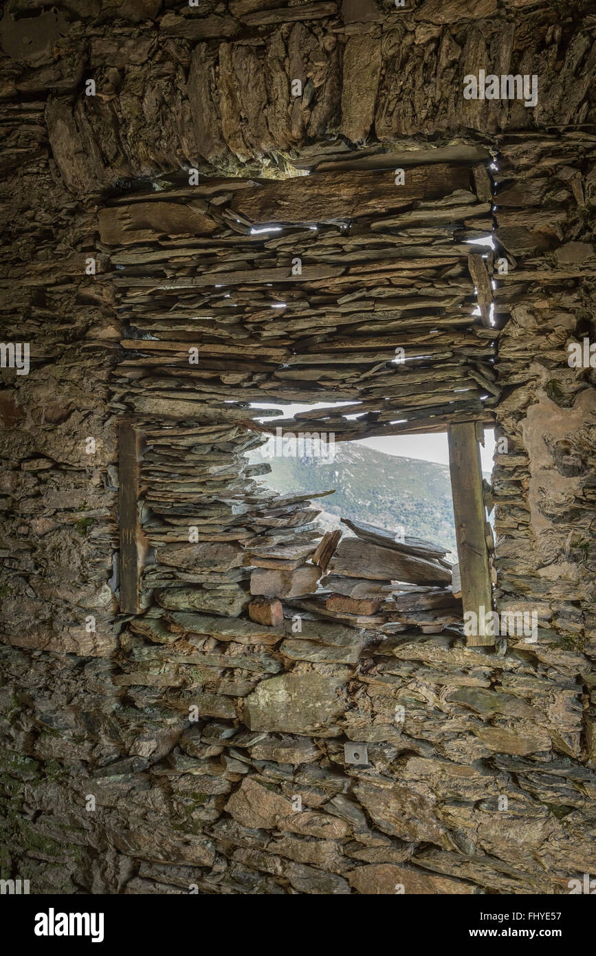 View of mountain through stone framed window of Glaciere ice storage ...