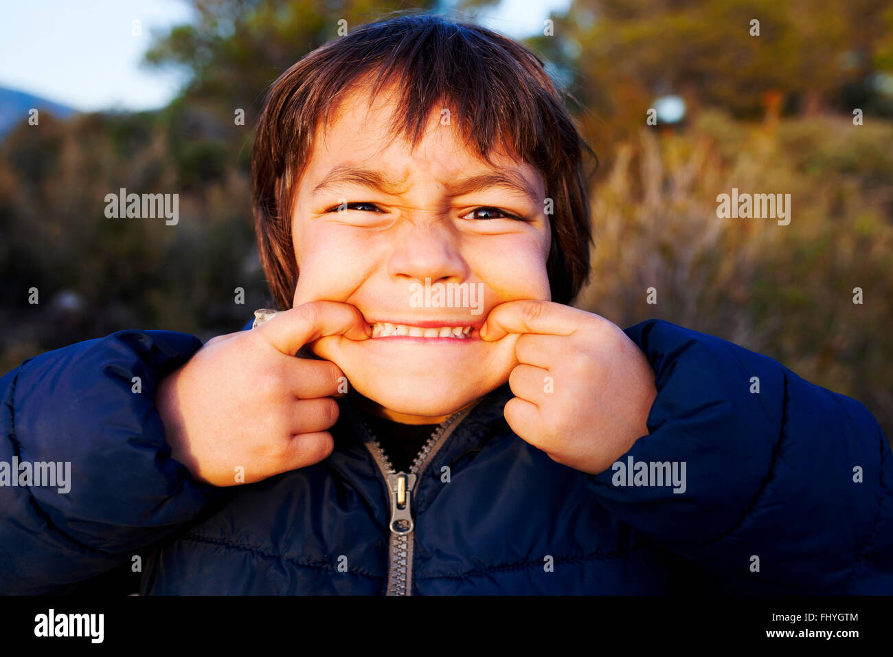 Portrait of little boy pulling funny faces Stock Photo - Alamy